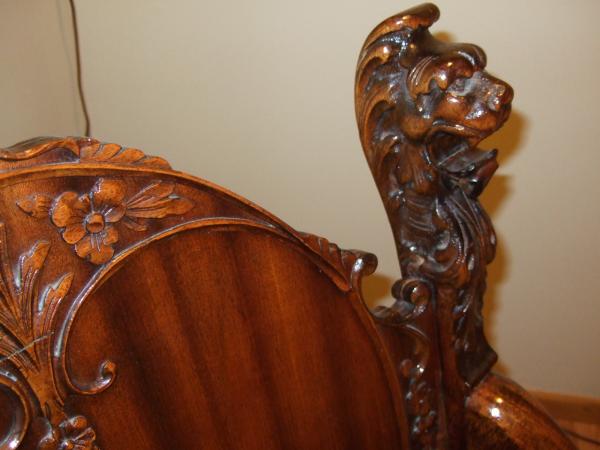 Rocking chair with carved lion heads | InstAppraisal